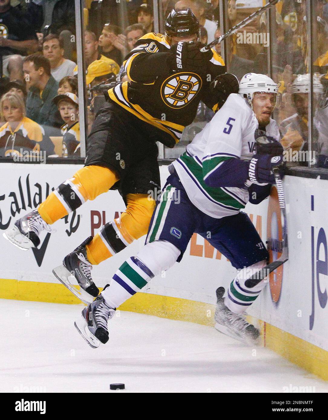 Boston Bruins left wing Daniel Paille (20) checks Vancouver Canucks ...