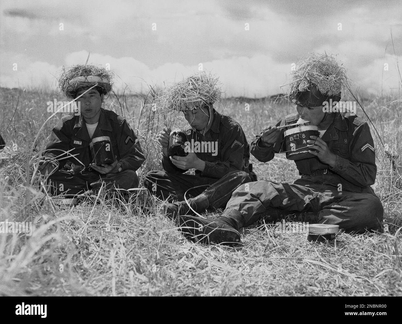 Troops eat their noon rations of rice and baked fish at the maneuver ...