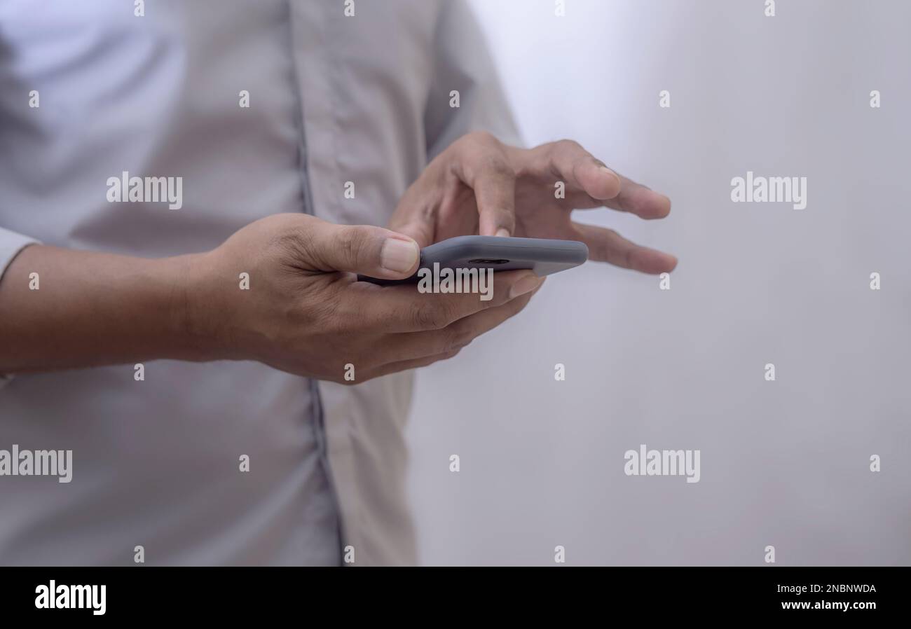 Human using smart phone mobile on blurred background Stock Photo - Alamy
