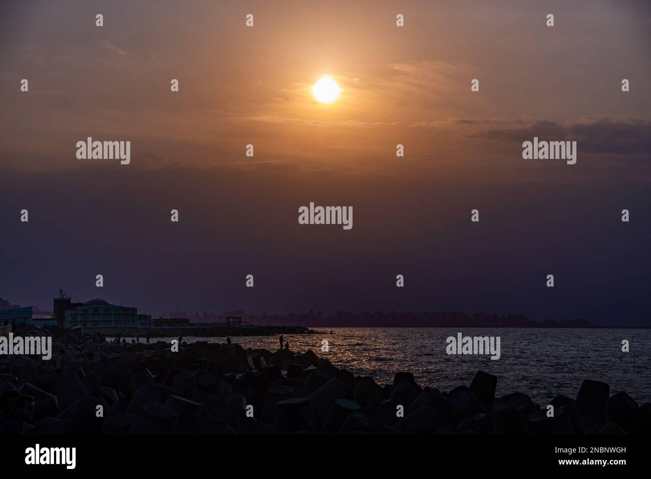 An aerial view of sea with rocky beach during susnet Stock Photo - Alamy