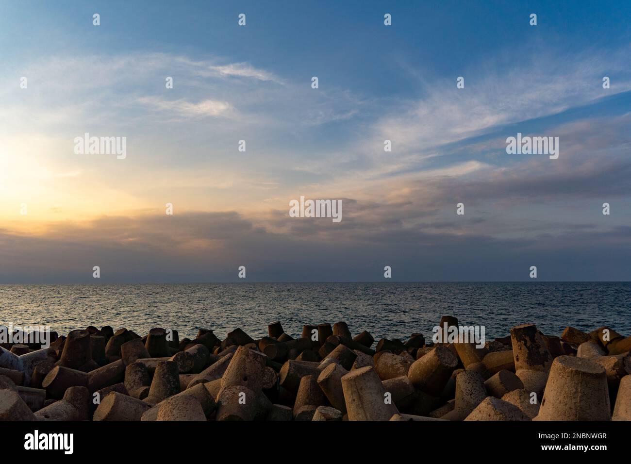 An aerial view of sea with rocky beach during susnet Stock Photo - Alamy