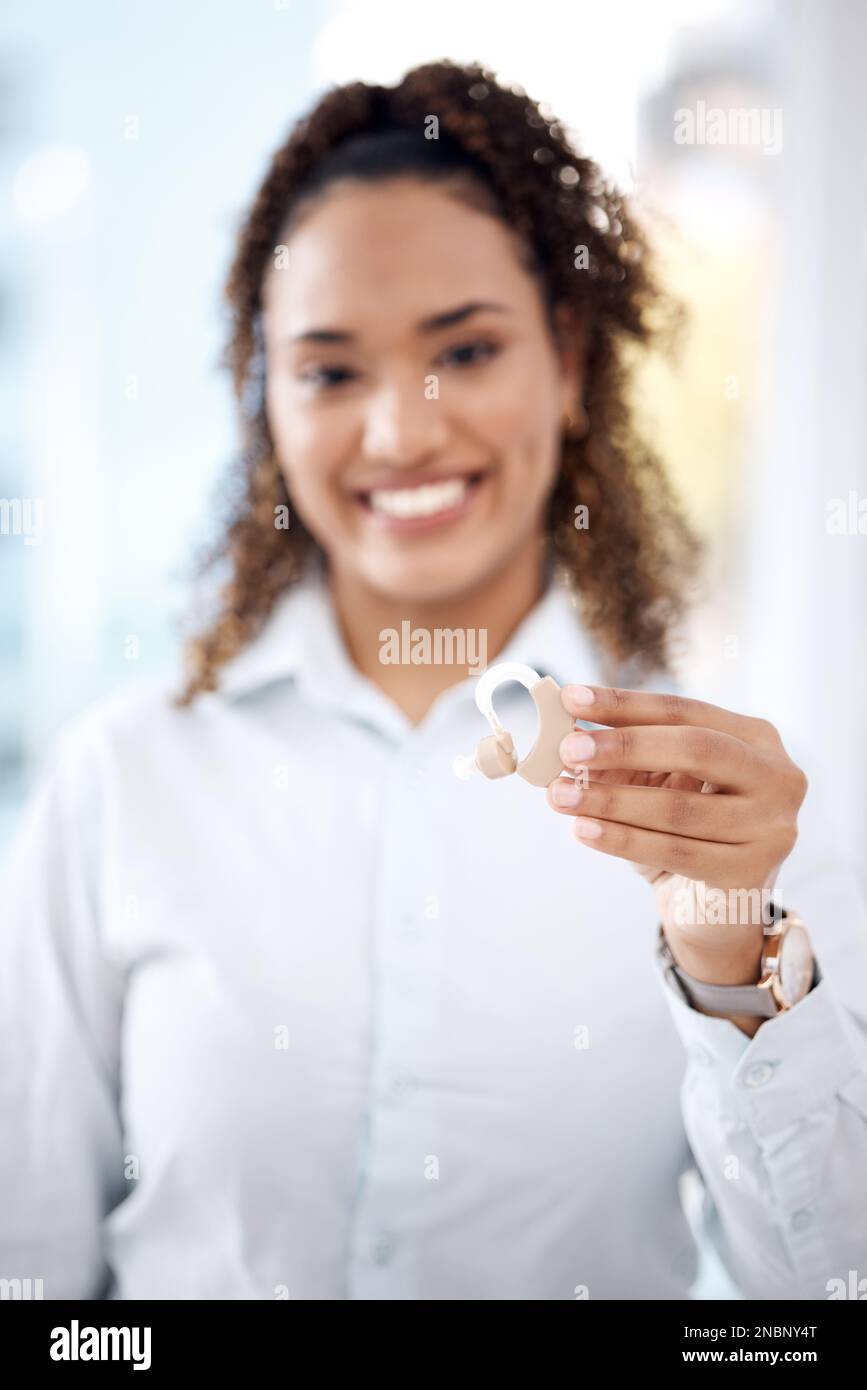 Hand, hearing aid and audiology with a black woman holding a listening ...