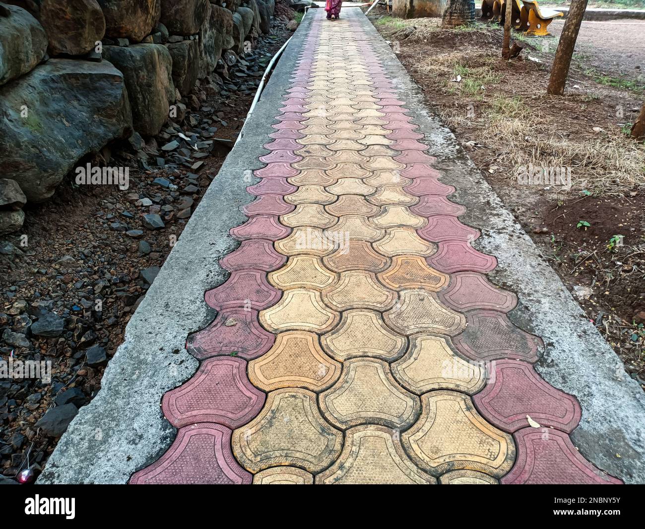 A red and yellow color interlocking concrete paver blocks pathway in ...