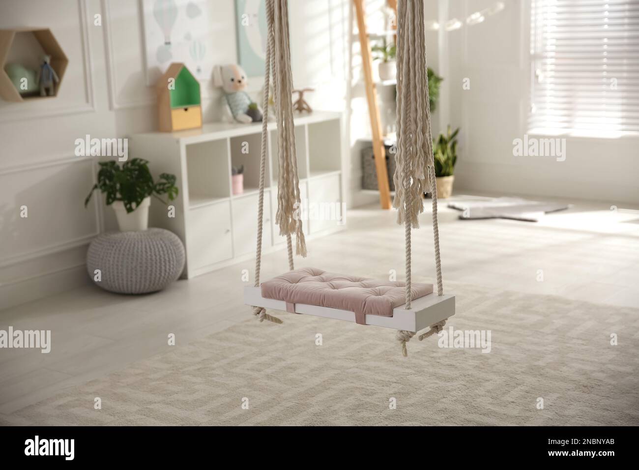 Beautiful swing in room. Stylish interior design Stock Photo - Alamy