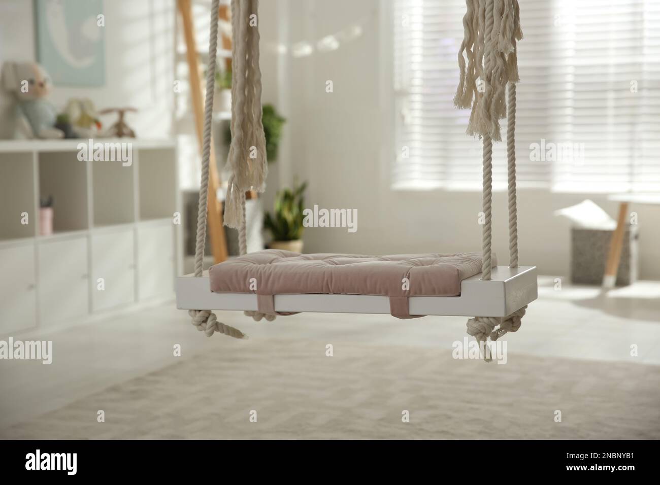 Beautiful swing in room. Stylish interior design Stock Photo - Alamy