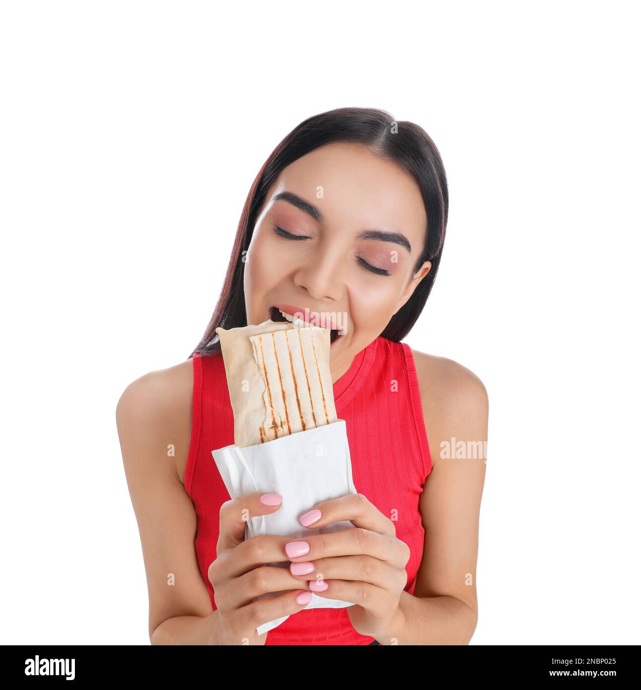 Young woman eating delicious shawarma on white background Stock Photo ...