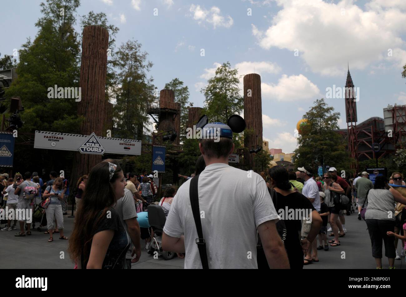Tourists stand outside the entrance to the Star Tours motion simulation ...