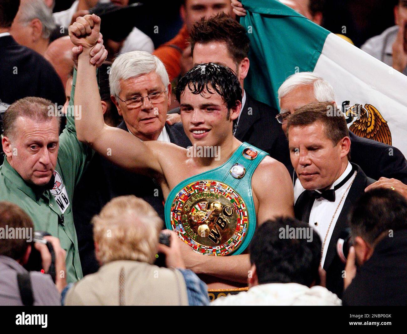 Julio Cesar Chavez, Jr., center, of Mexico poses with his belt along ...