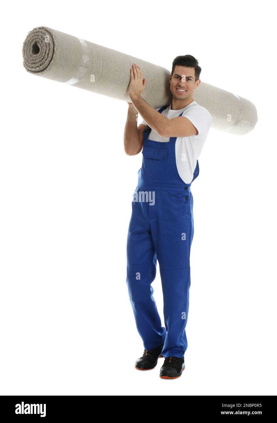 Male worker with rolled carpet on white background Stock Photo - Alamy