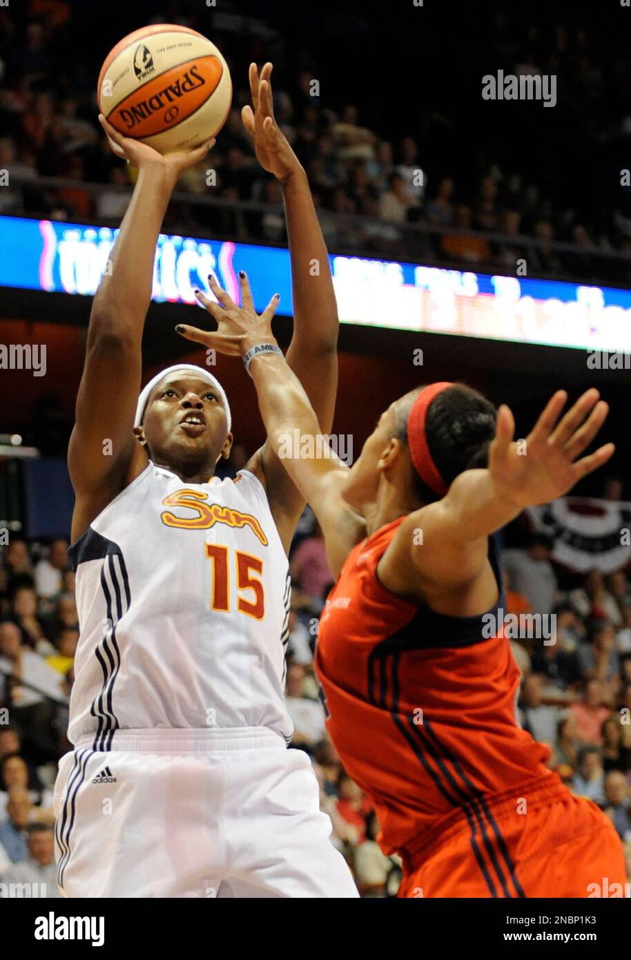 Connecticut Sun's Asjha Jones, left, shoots a basket while guarded ...