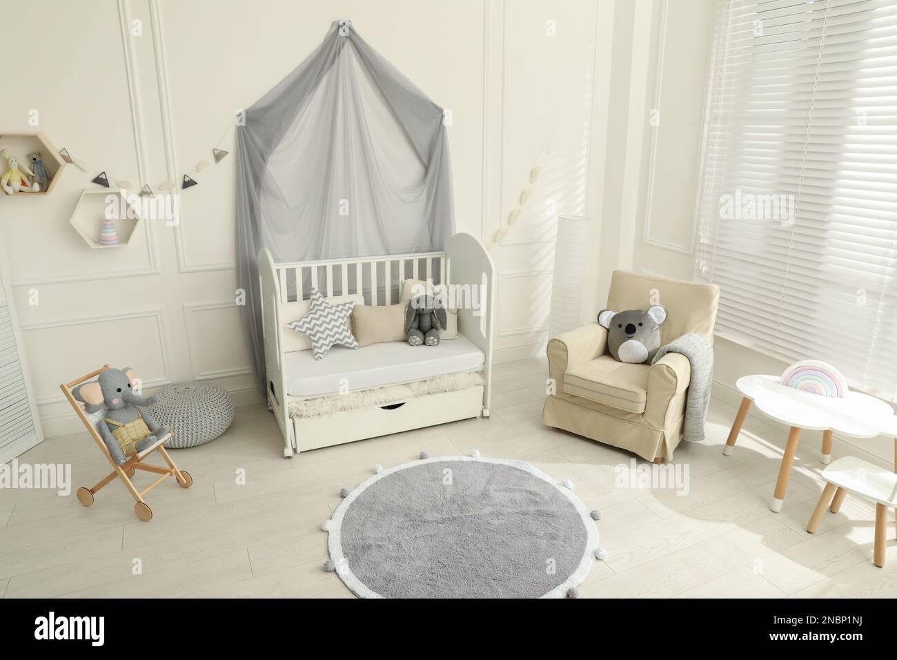 Cozy baby room interior with crib and toys Stock Photo - Alamy