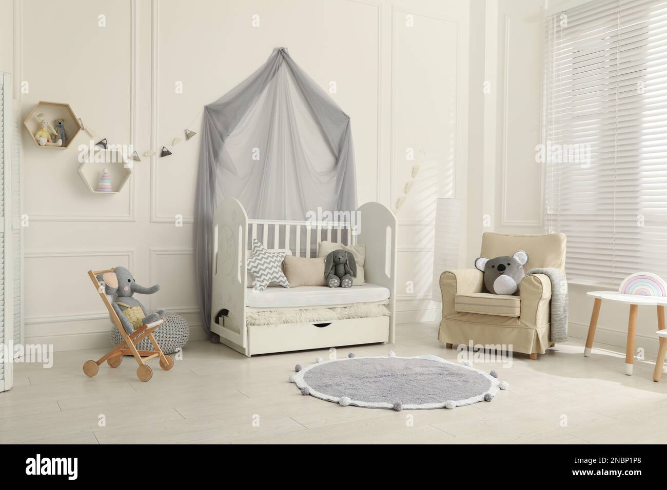 Cozy baby room interior with crib and toys Stock Photo - Alamy