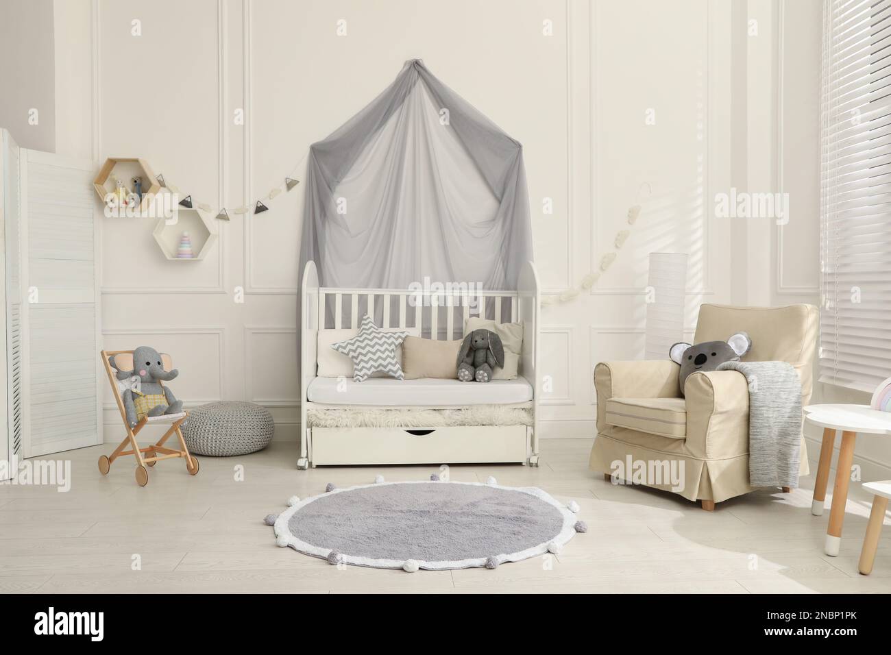 Cozy baby room interior with crib and toys Stock Photo - Alamy