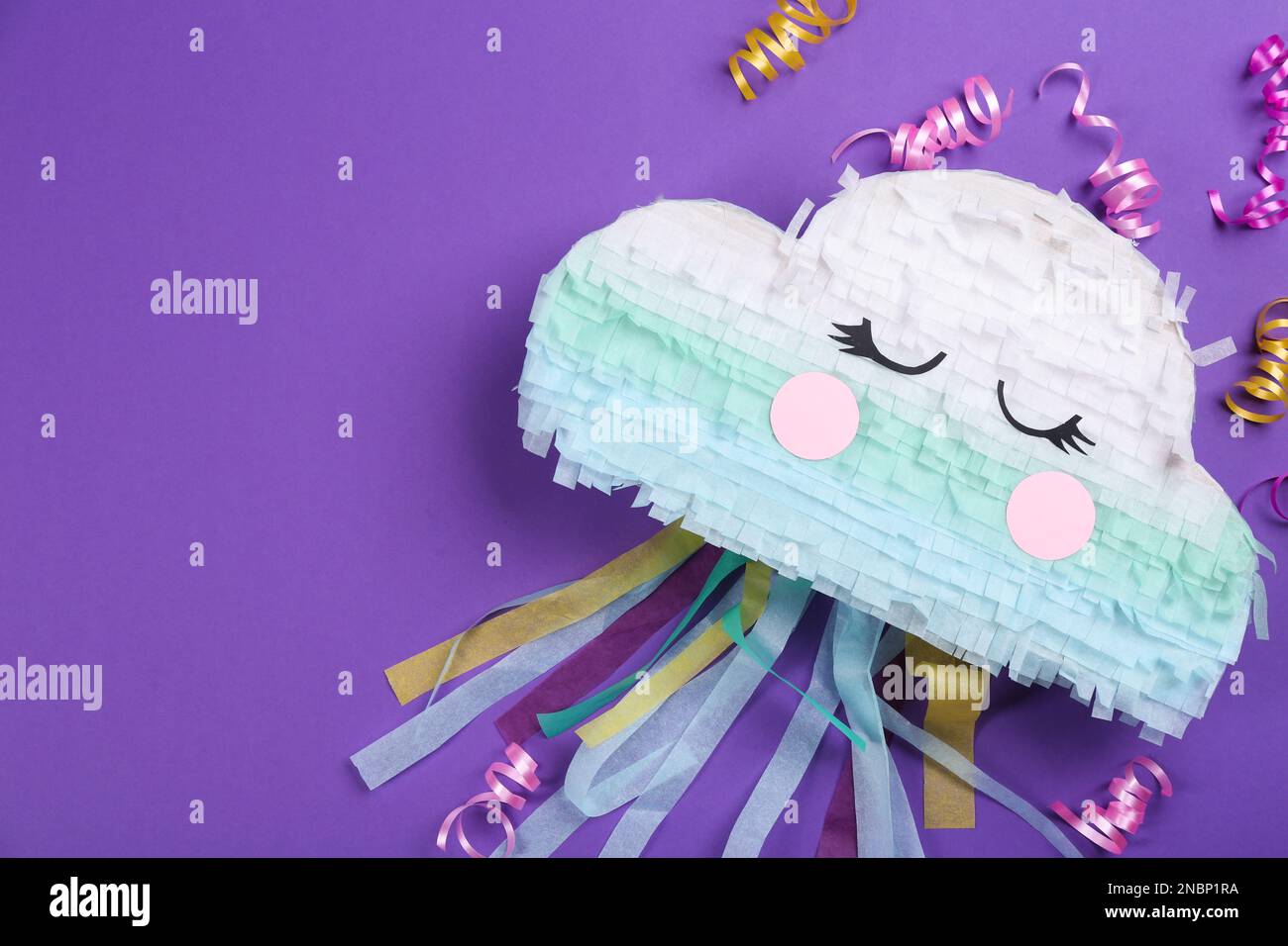 Cloud shaped pinata and streamers on purple background, flat lay. space ...