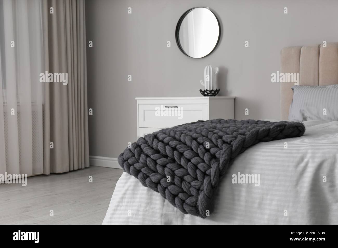 Knitted merino wool plaid on bed in room Stock Photo - Alamy