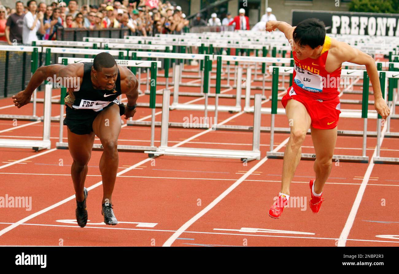 Hurdlers David Oliver, left, and Liu Xiang, from China, look at each ...