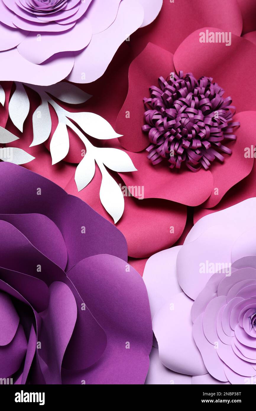 Different beautiful flowers and branches made of paper as background ...