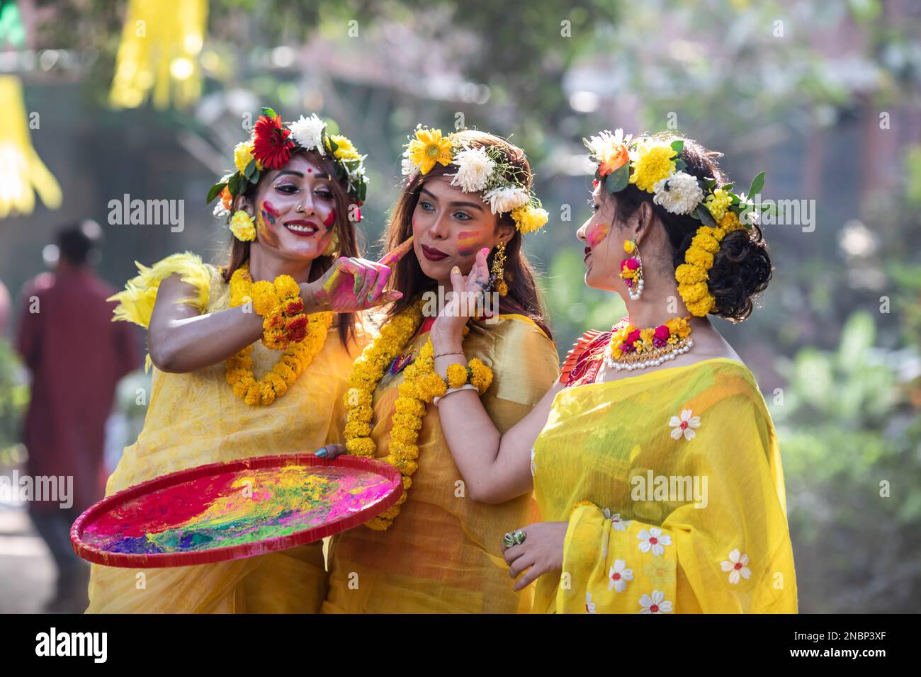 Dhaka, Bangladesh. 14th Feb, 2023. Women smear colour powder on each other during Basanto Utsav ...