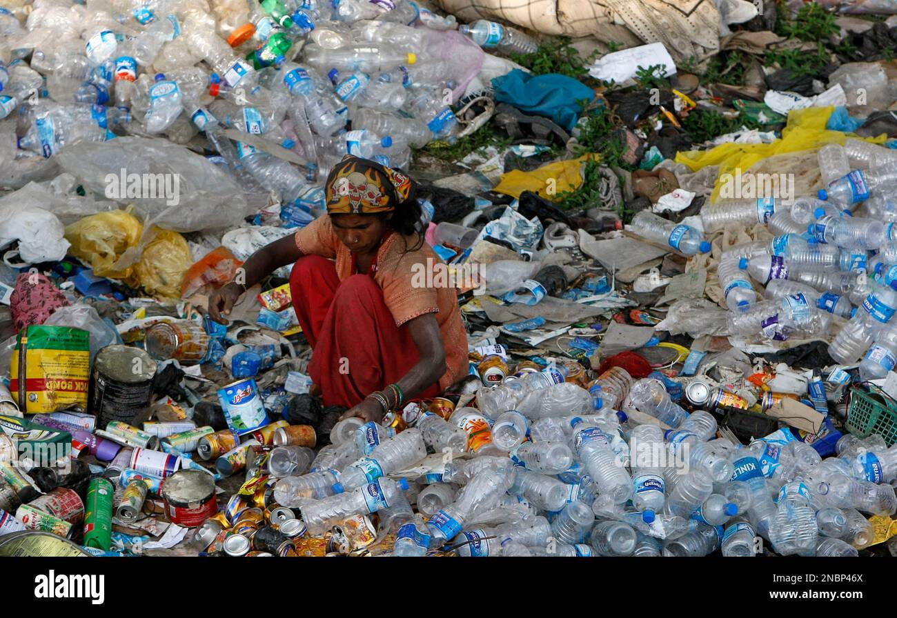 A Nepalese rag picker collects recyclable material from a garbage dump ...