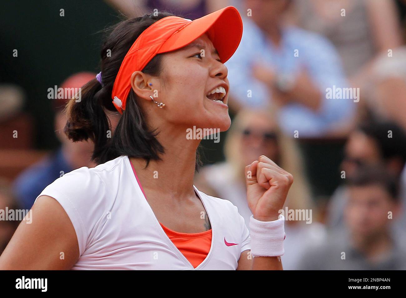 Li Na of China clenches her fist after scoring against Francesca ...