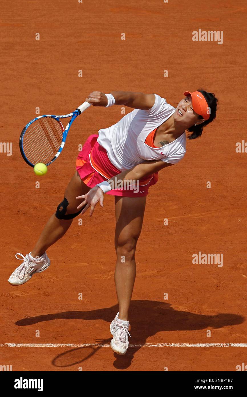 Li Na of China serves against Francesca Schiavone of Italy in the women ...