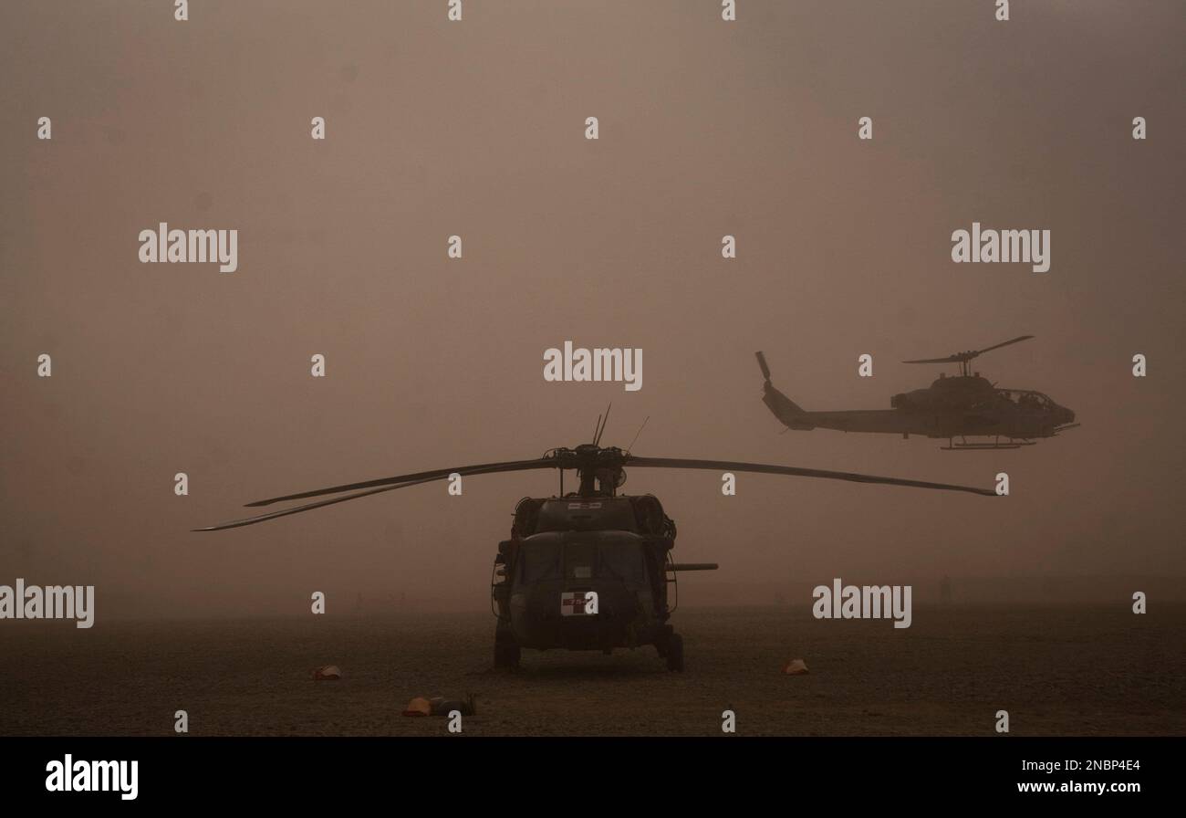 A helicopter with the US marines make their way through heavy sandstorm ...