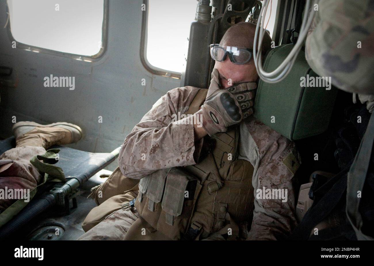 United States Marine Joshua Barron reacts onboard a medevac helicopter ...