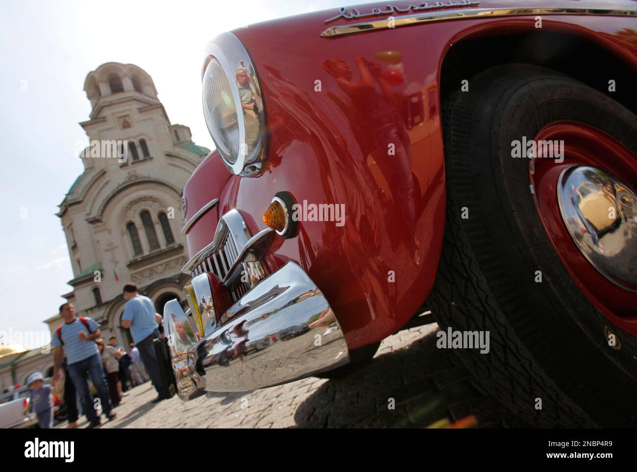 Visitors walk next to a Polish made 1963 Warshawa car, displayed during ...