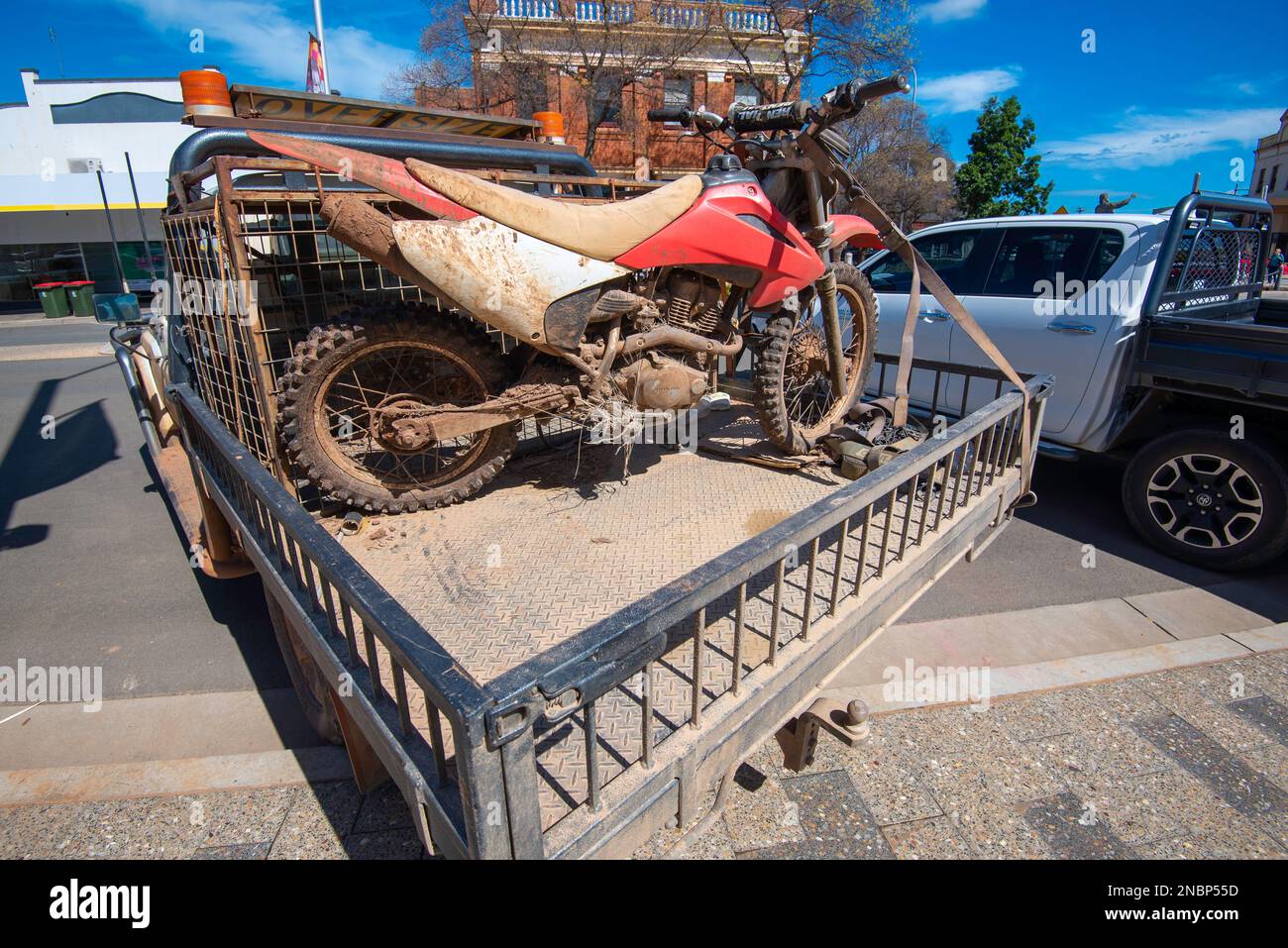 A agricultural or farm motorbike mounted on the back of a 4WD ute ...