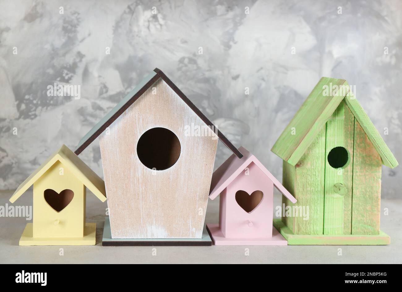 Collection of handmade bird houses on light grey stone background Stock ...