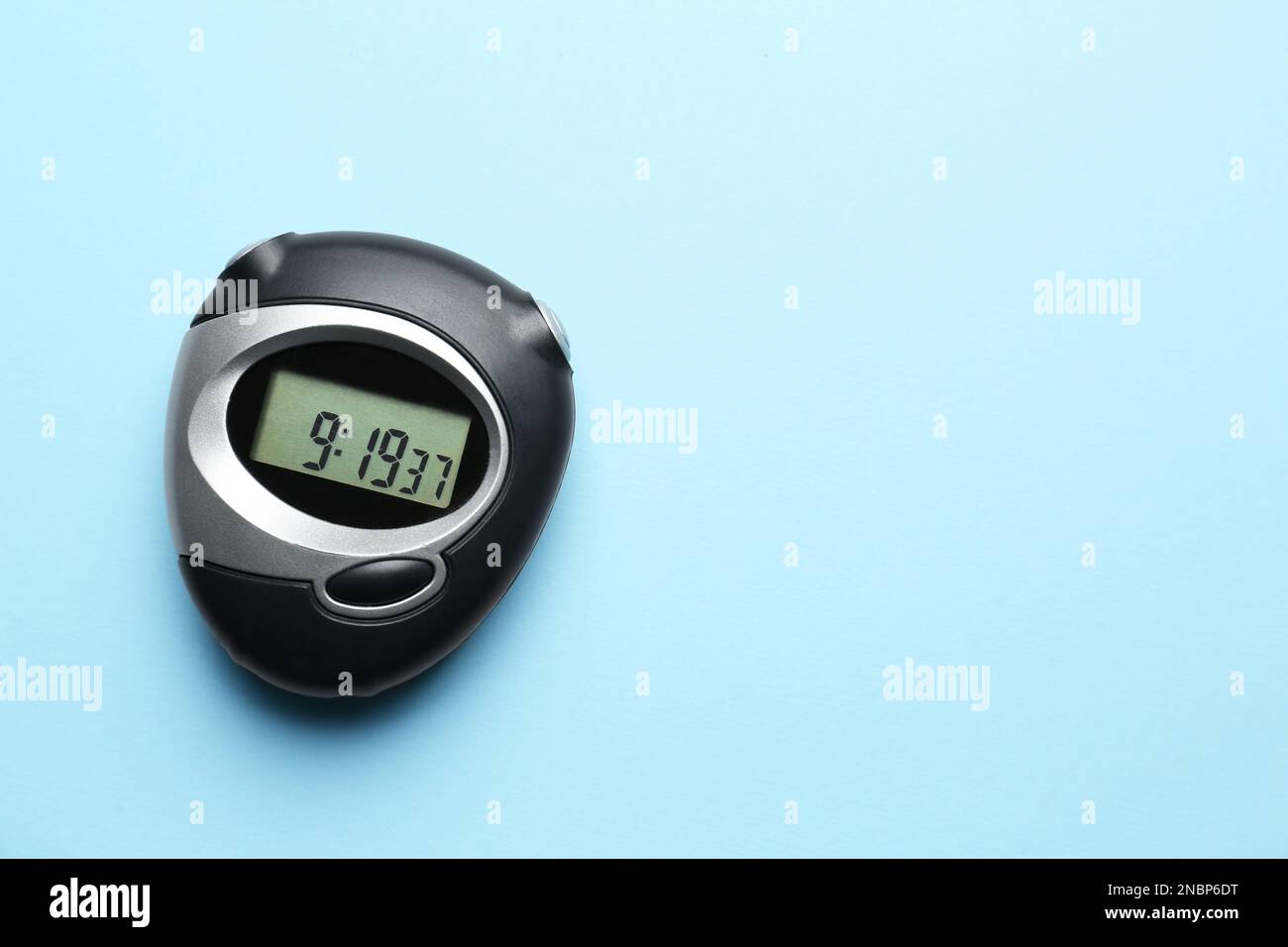 Digital timer on light blue background, top view. Space for text Stock ...