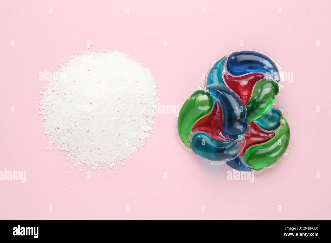 Laundry capsules and washing powder on pink background, flat lay Stock ...