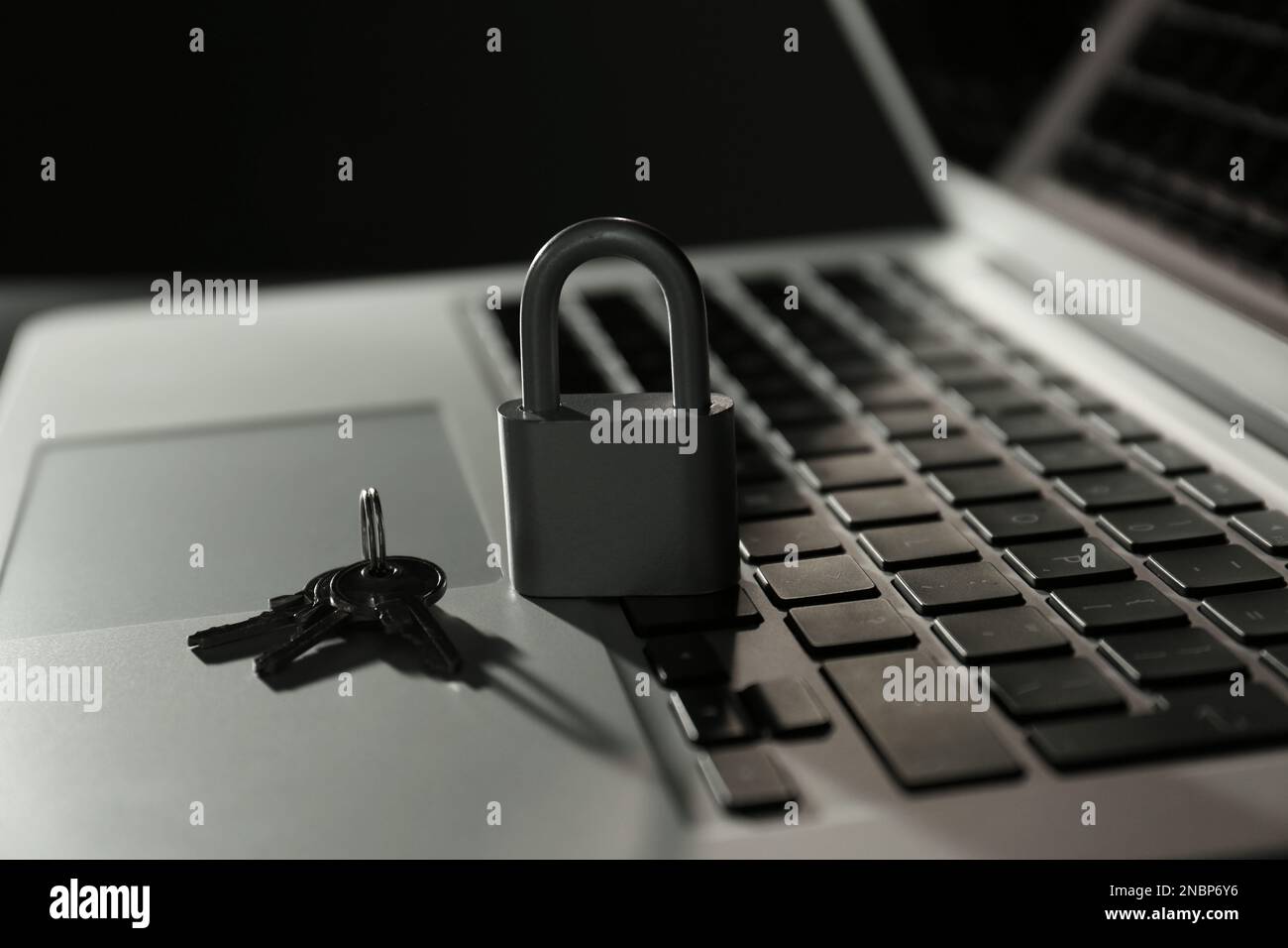 Metal lock, keys and laptop on dark background, closeup. Cyber security ...