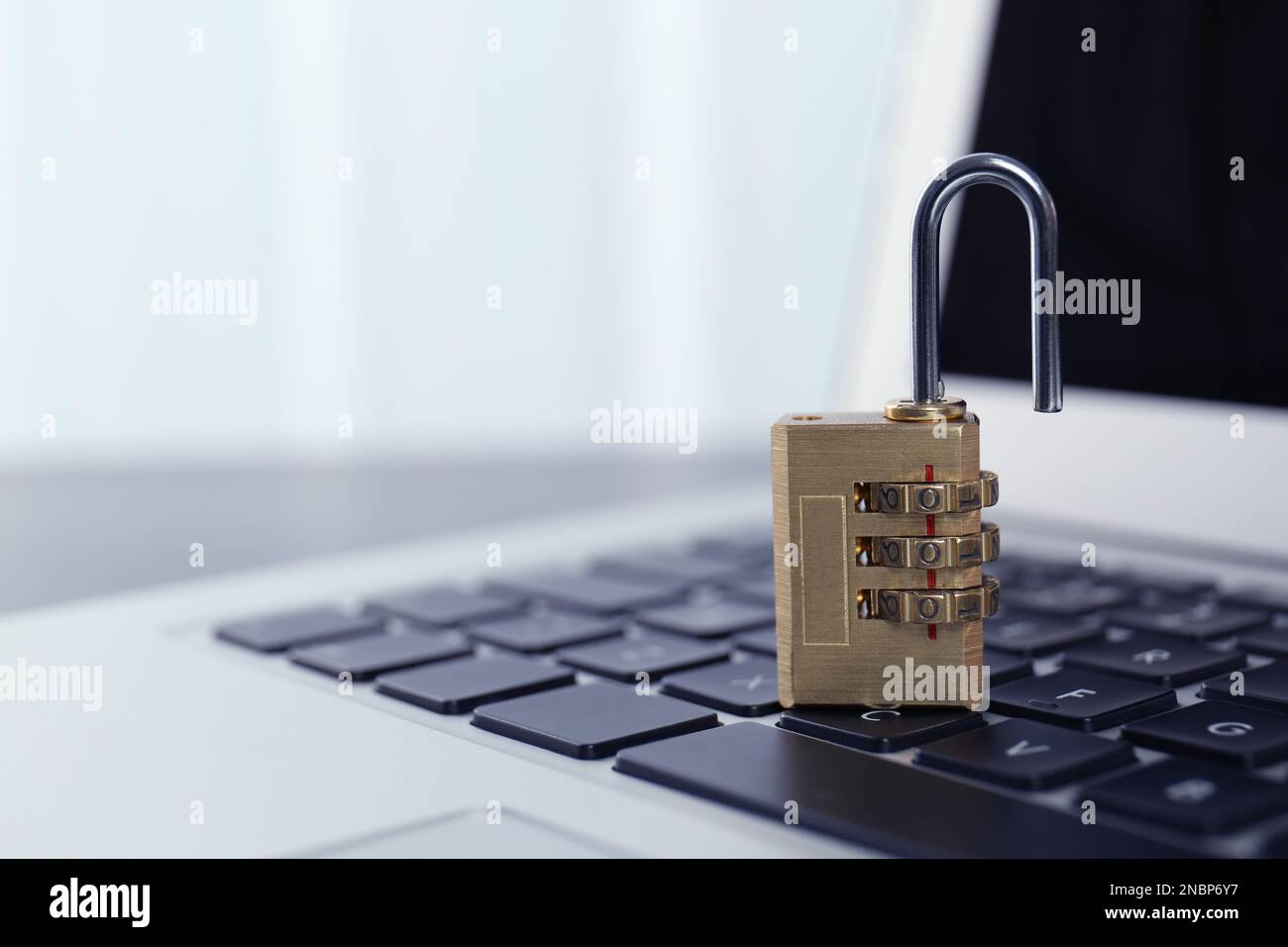 Metal code padlock on laptop keyboard, space for text. Cyber security ...