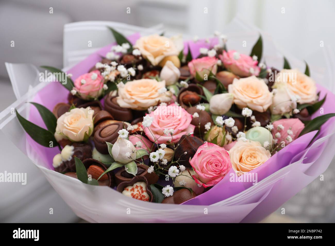 Beautiful food bouquet of sweets and flowers on light background Stock ...
