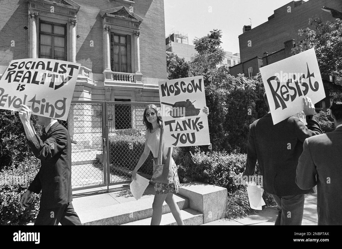 Several of many sign-carrying pickets before the Soviet Embassy march ...