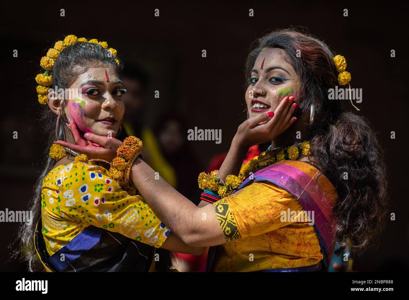 Dhaka, Bangladesh. 14th Feb, 2023. Women smear colour powder on each other during Basanto Utsav ...
