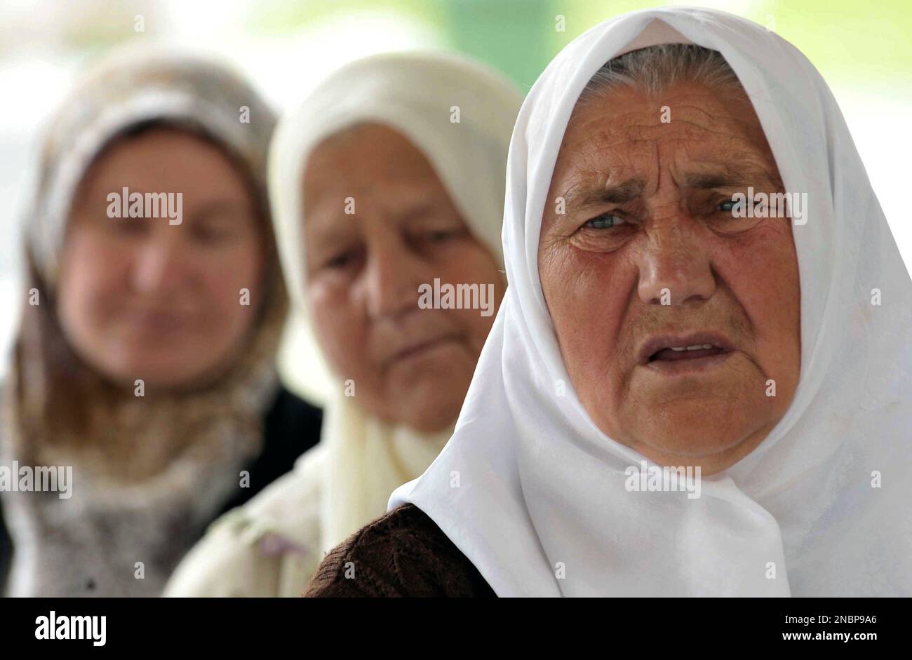 Bosnian Muslim women from Srebrenica watch the television broadcast of ...