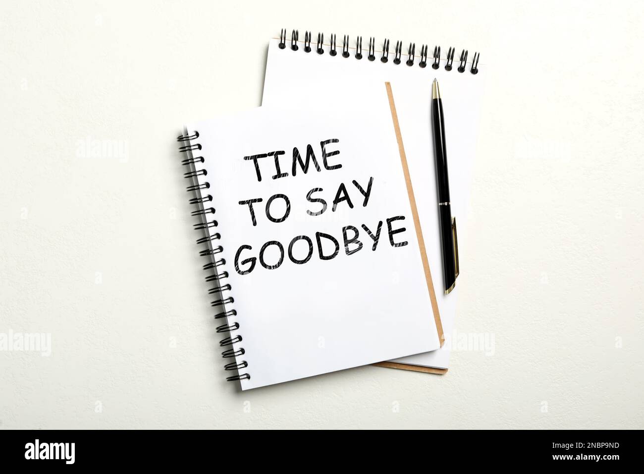 Notebook with text Time to say goodbye on white background, flat lay ...