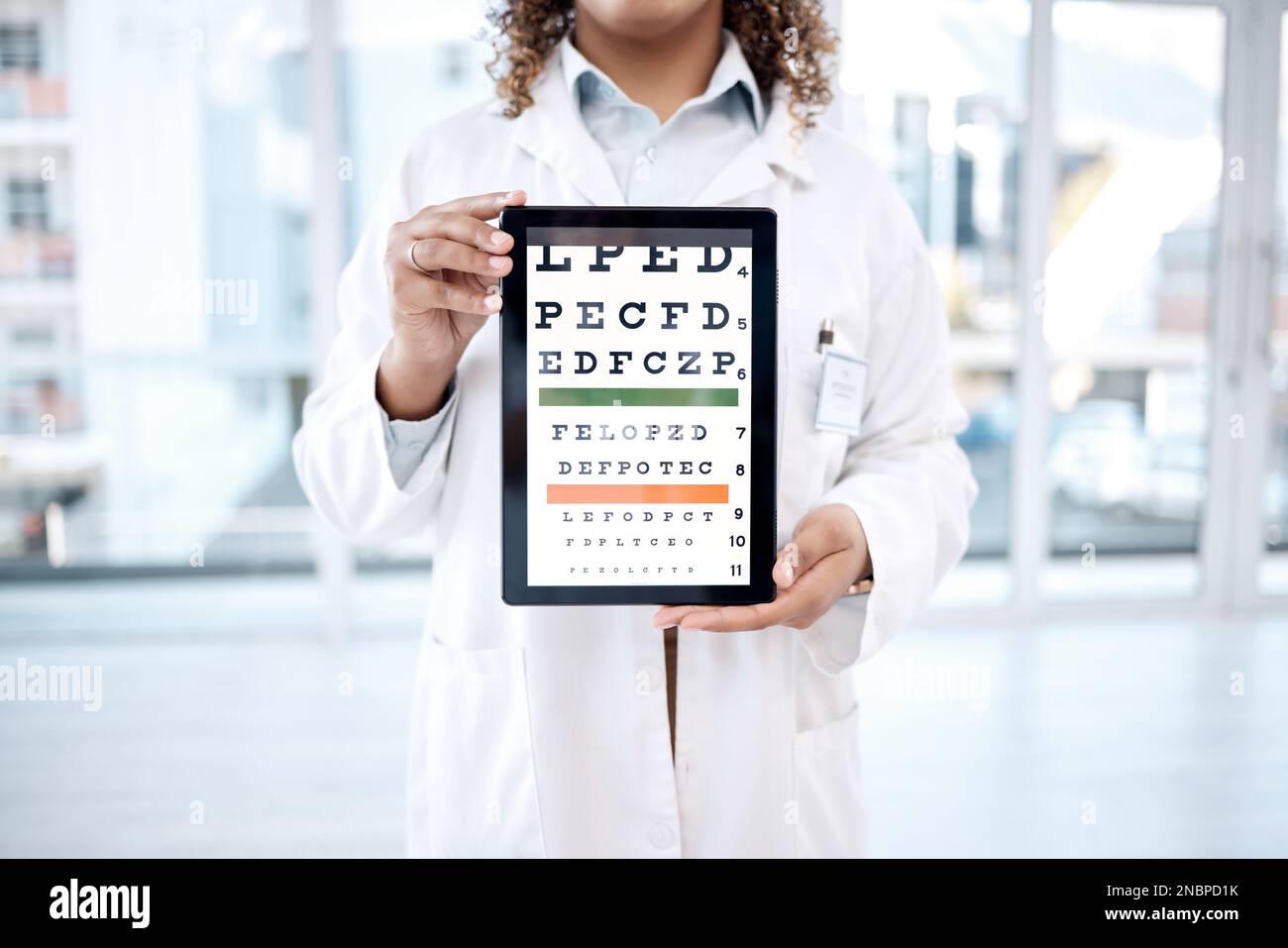 Hands, optometry chart and tablet screen in hospital for vision ...