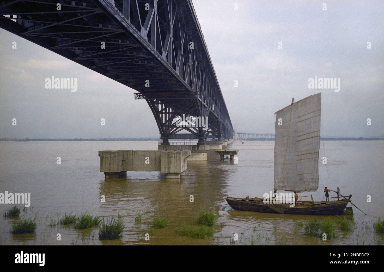 A Chinese junk vessel passes beneath the Nanking Yangtze River Bridge ...