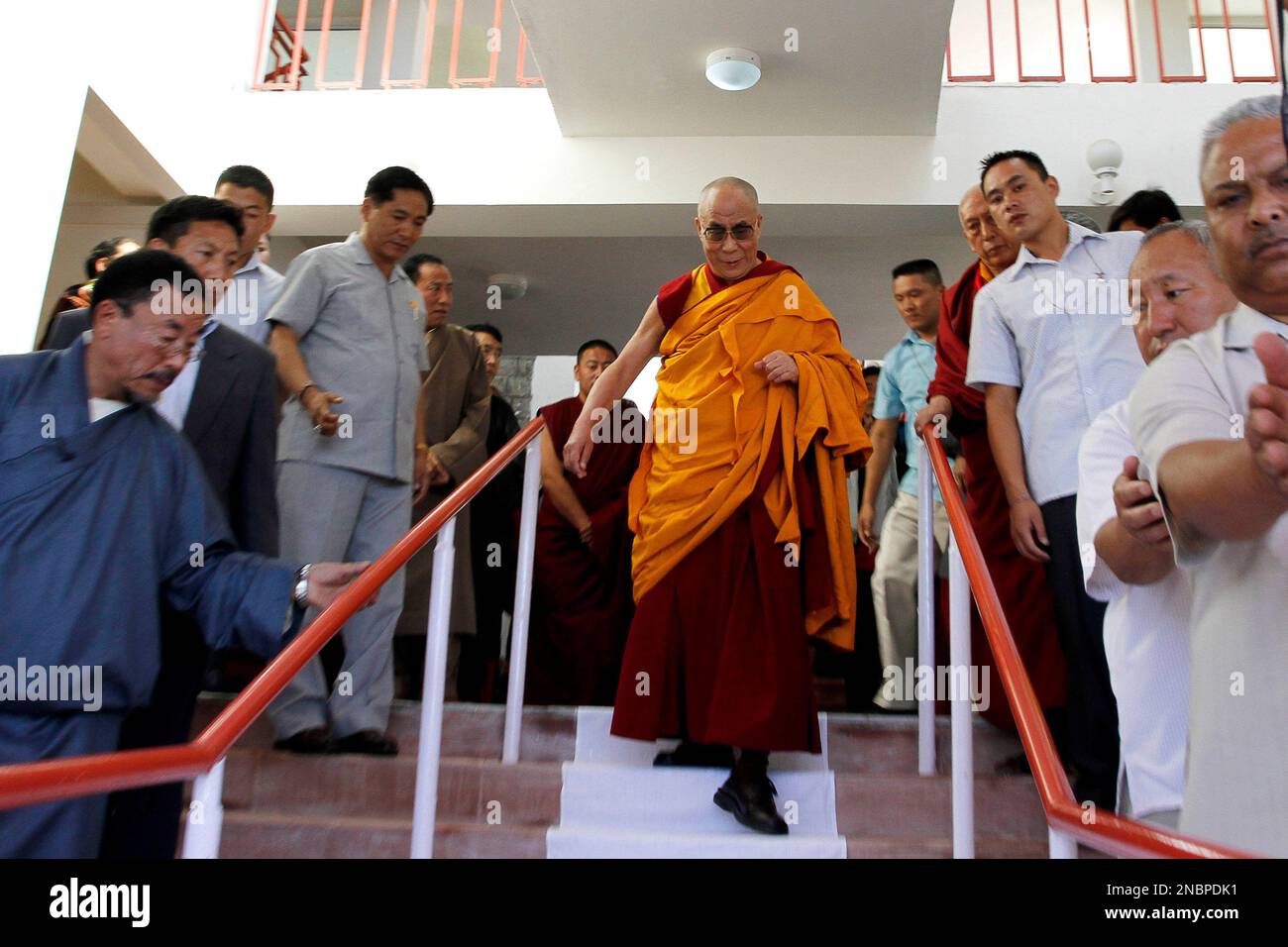 Tibetan spiritual leader the Dalai Lama descends stairs after ...