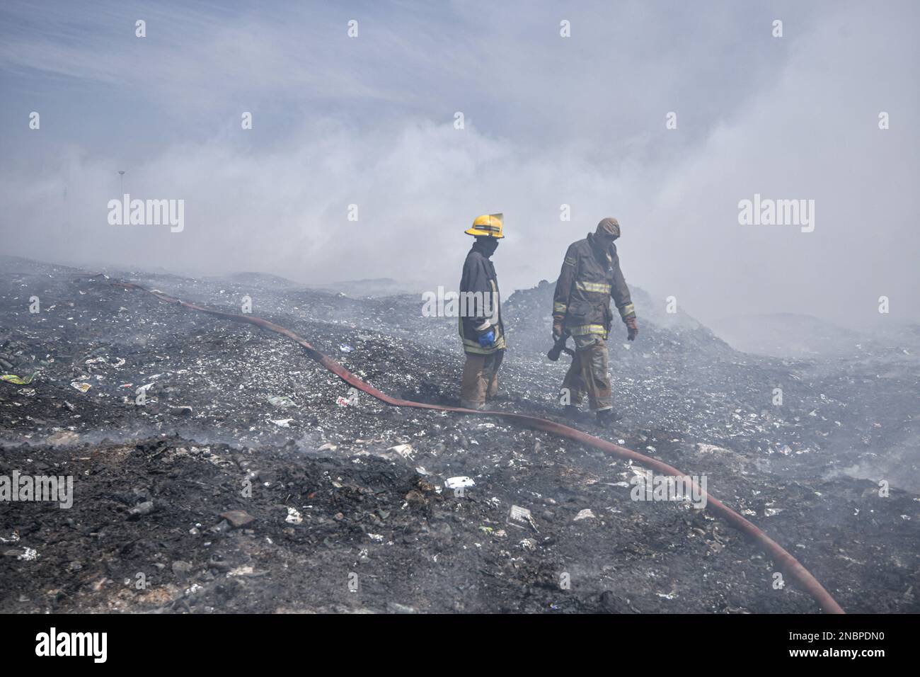 Nakuru, Kenya. 13th Feb, 2023. Firefighters walk in an area filled with ...