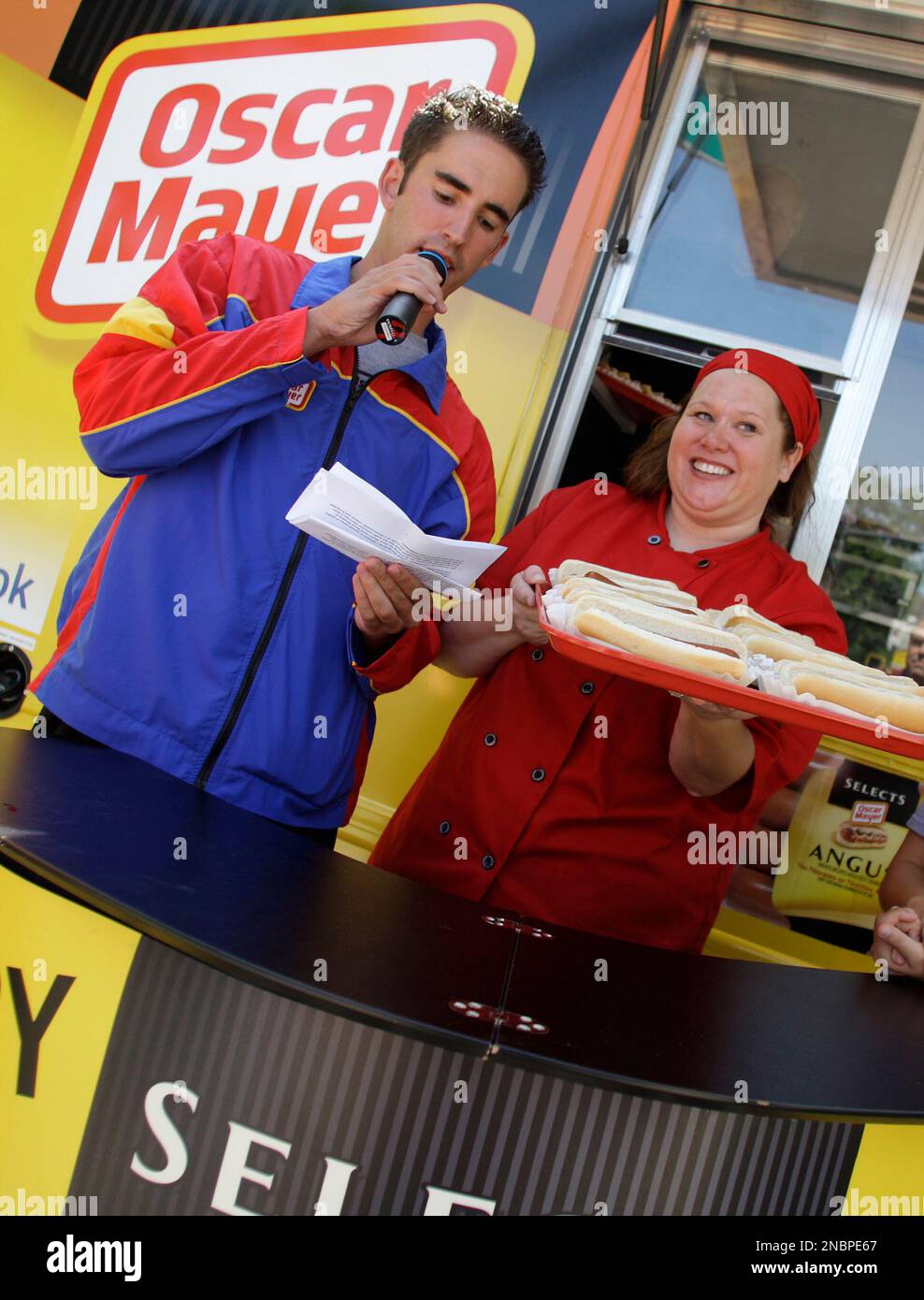Liz Lessner, right, from Dirty Franks Hot Dog Palace, prepares to pass ...