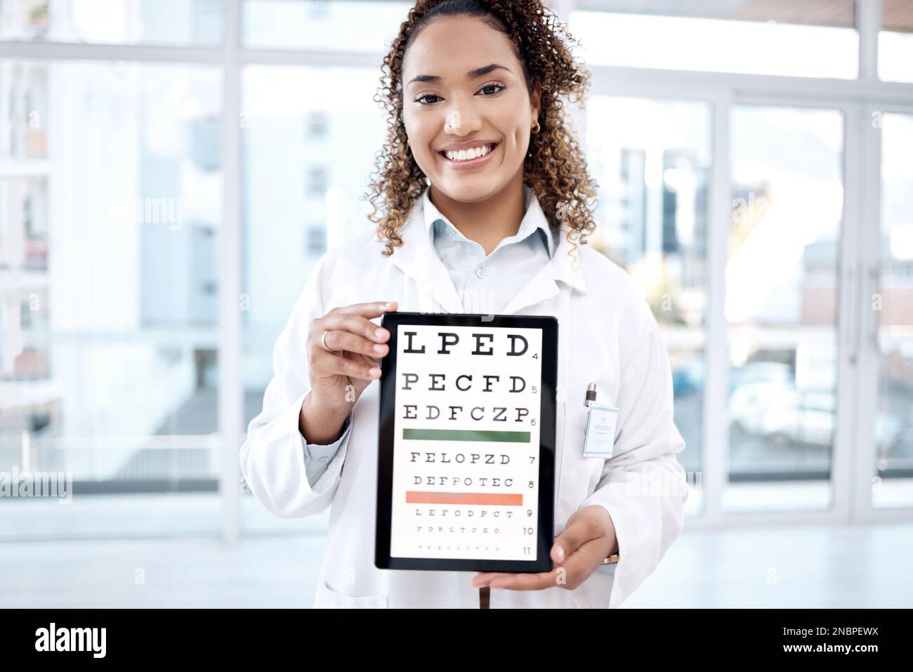 Portrait, eye chart and doctor with tablet in hospital for vision ...