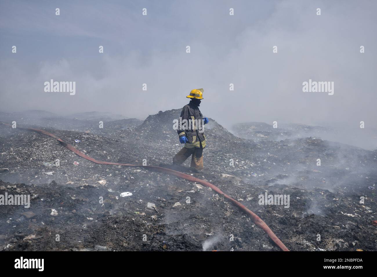 Nakuru, Kenya. 13th Feb, 2023. A firefighter walks in an area filled ...
