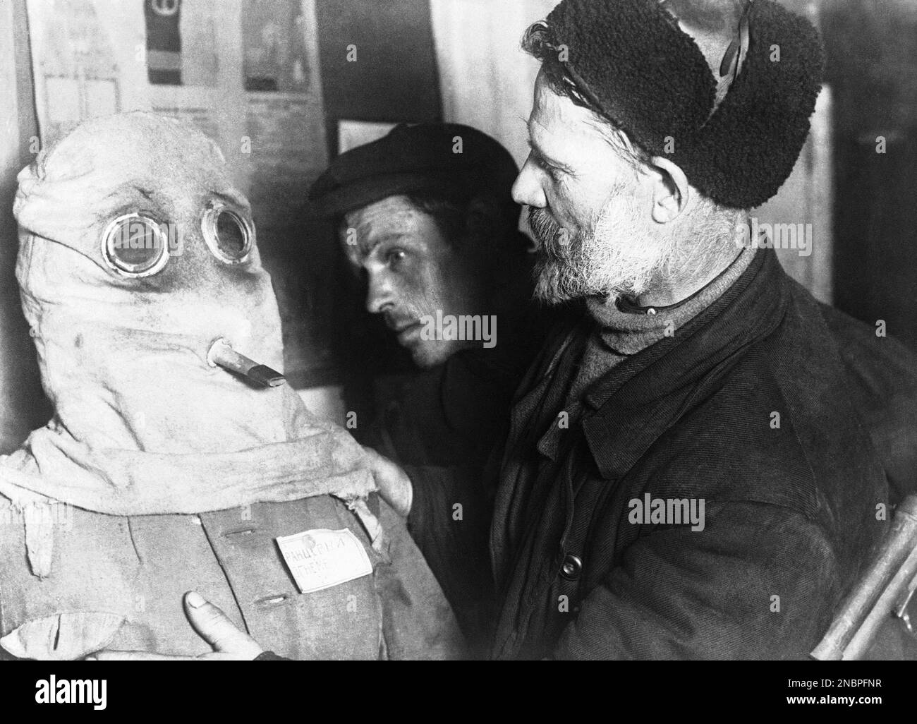 Two local people looks at a gas marks on display at the Moscow Farmers ...
