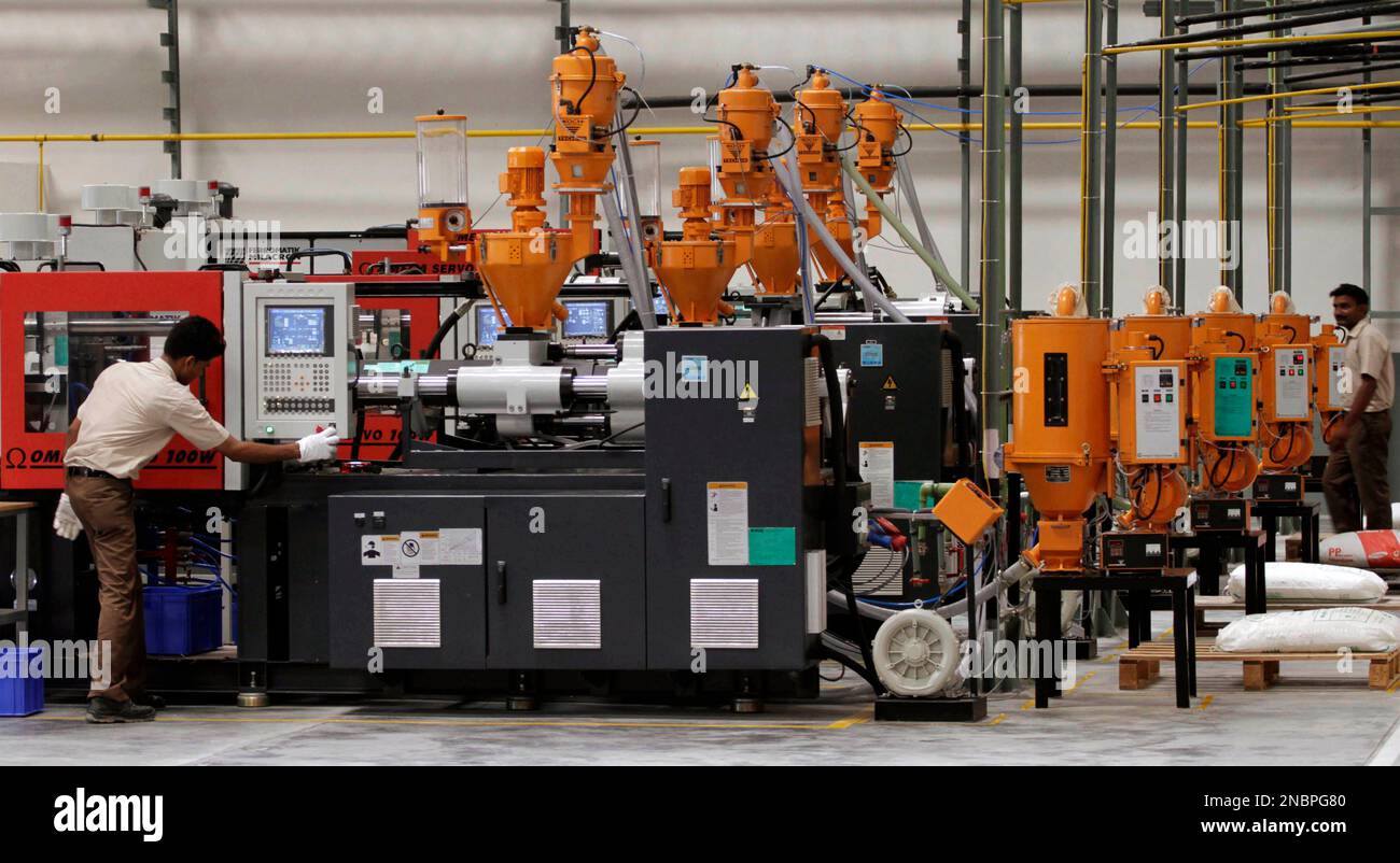 An Indian man works at a newly inaugurated manufacturing plant of ...