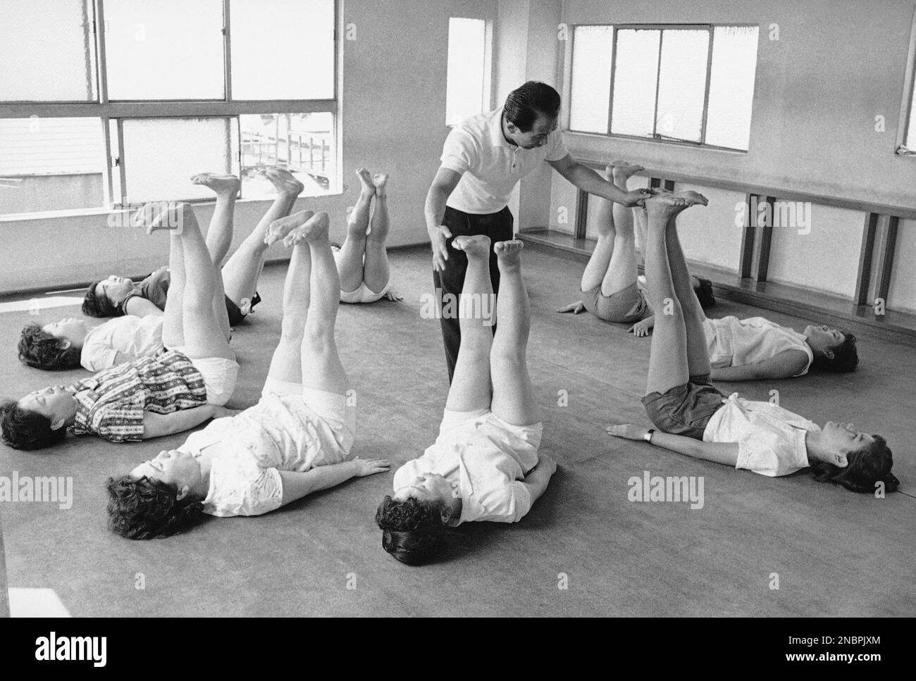 A specialist in weight reducing exercises, Shizuo Wada, conducts a ...