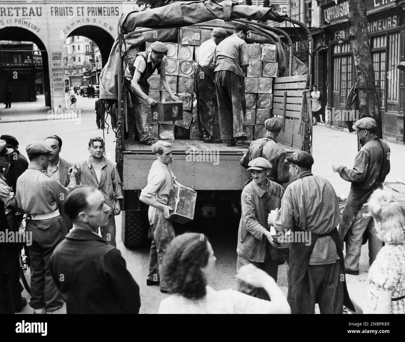 French workers unload food brought into Paris on August 26, 1944, the ...